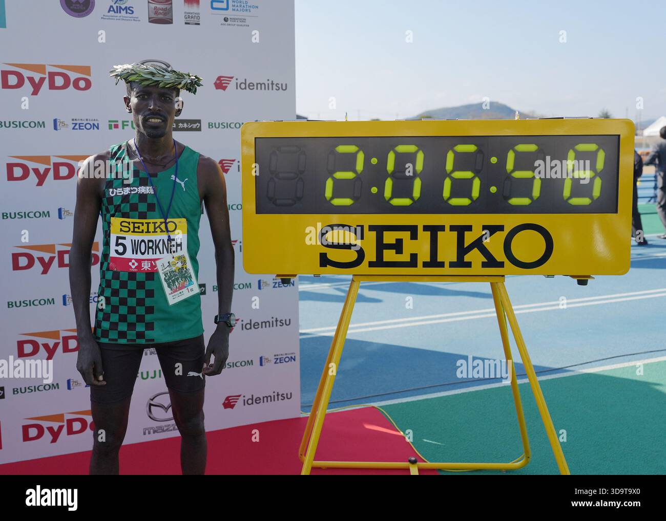 Workneh Derese of Ethiopia poses for photo after crossing the finish ...