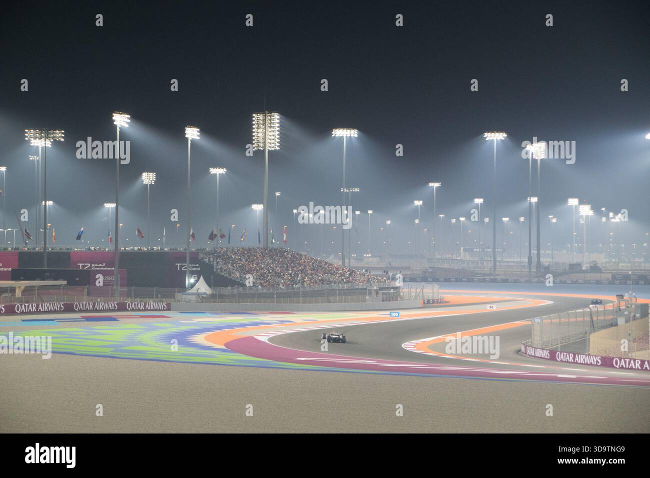 Cars speed around the circuit during the Qatar Grand Prix at night with ...