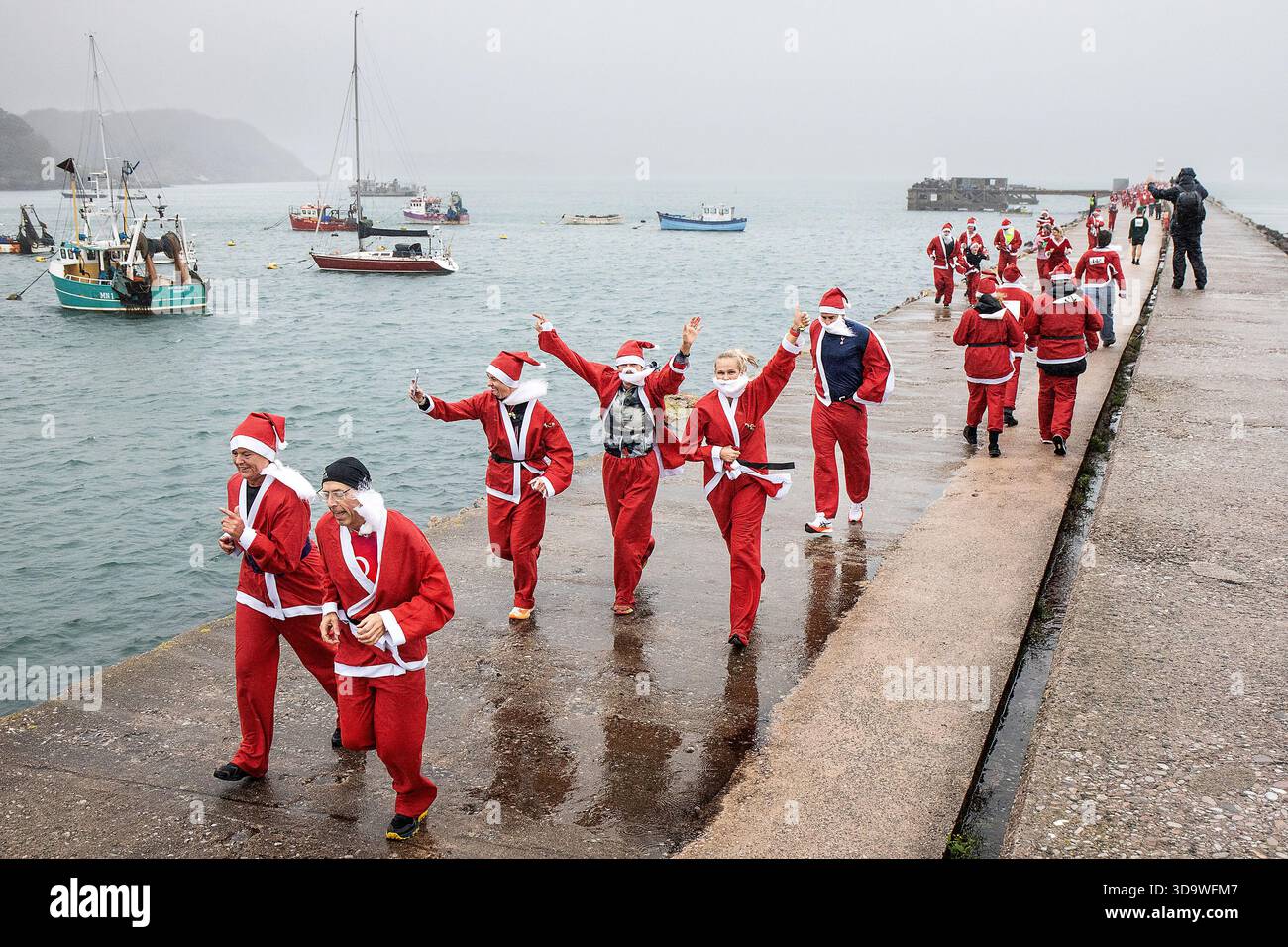 Brixham, UK, 7th Dec. 2025. Hundreds of Santas take part in the 2025 ...