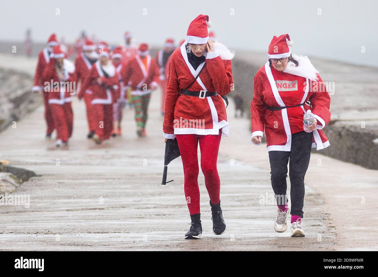 Brixham, UK, 7th Dec. 2025. Hundreds of Santas take part in the 2025 ...