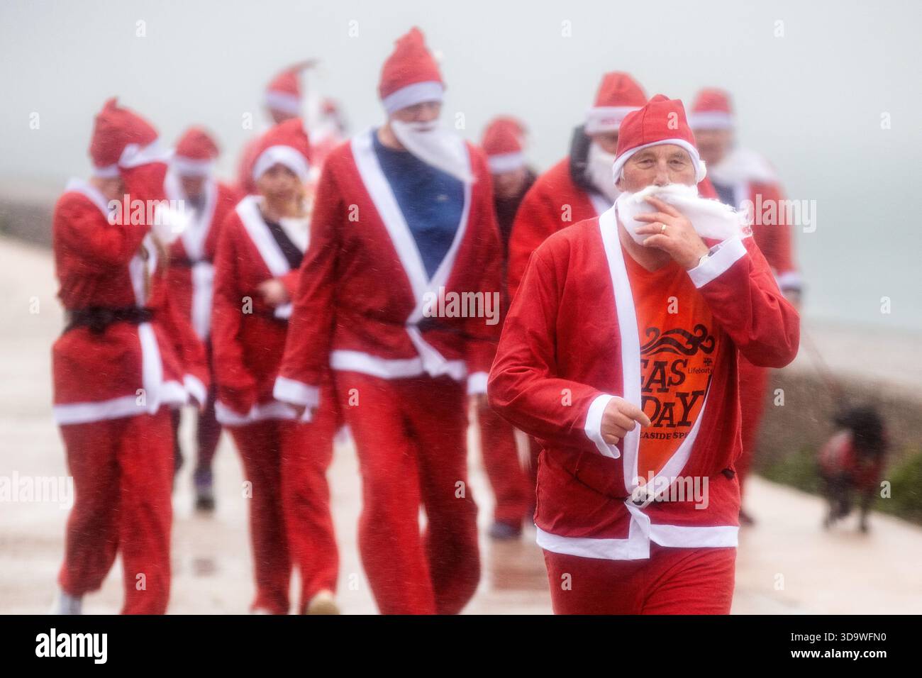 Brixham, UK, 7th Dec. 2025. Hundreds of Santas take part in the 2025 ...