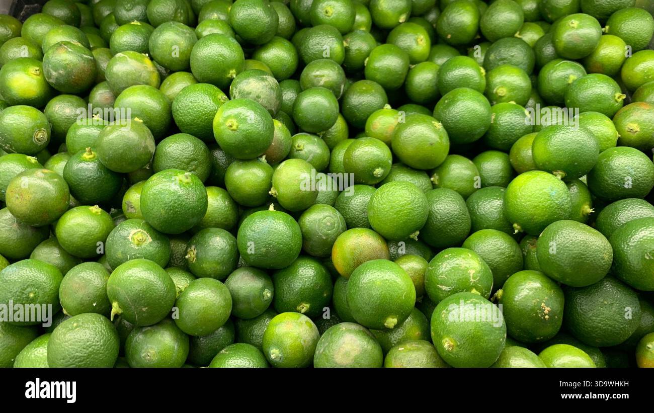 Top view of small limes display in a wet market Stock Photo - Alamy