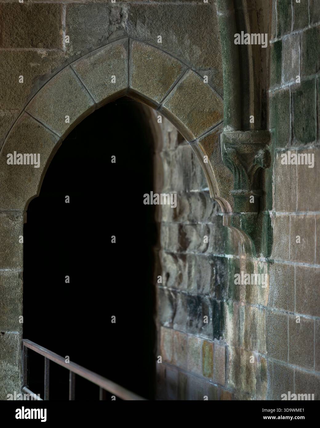 Gothic stone archway inside the historic Abbey of Mont Saint-Michel ...