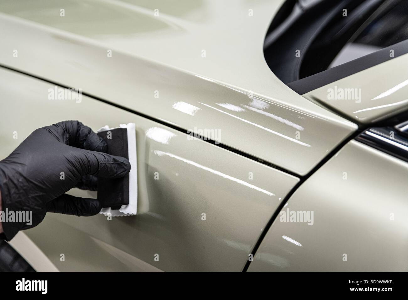 Ceramic coating application on car body panel using applicator during ...
