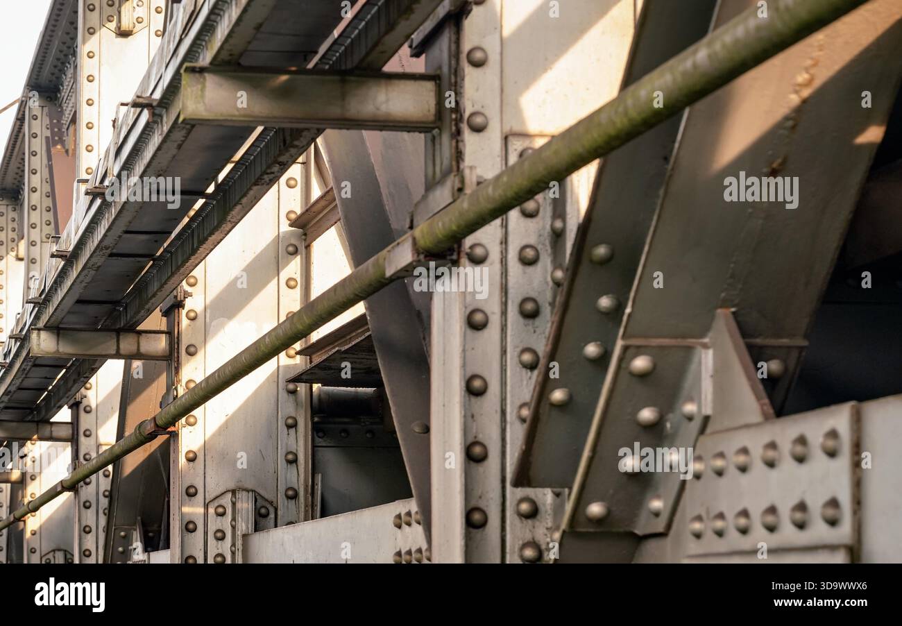 Rail bridge, detail on steel plates, joints, large nuts and bolts lit ...