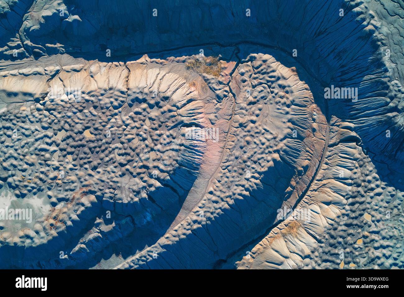 Dramatic abstract aerial view of a sculpted industrial waste dump. The ...