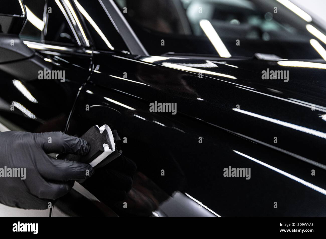 Ceramic coating application on glossy black car paint during ...