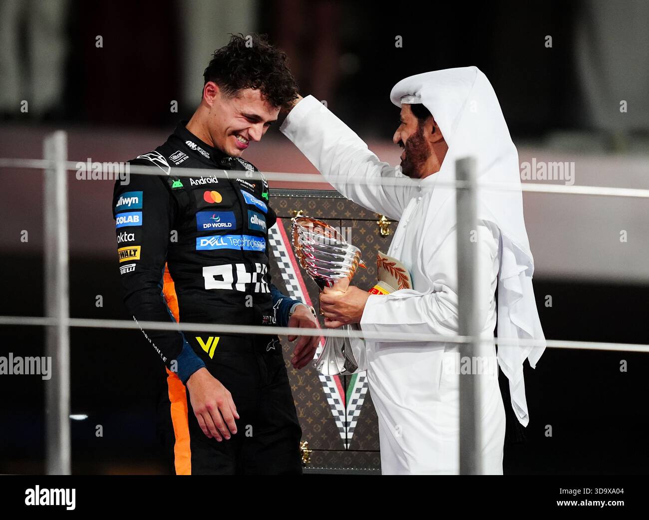 FIA President Mohammed Ben Sulayem (right) ruffles the hair of McLaren ...