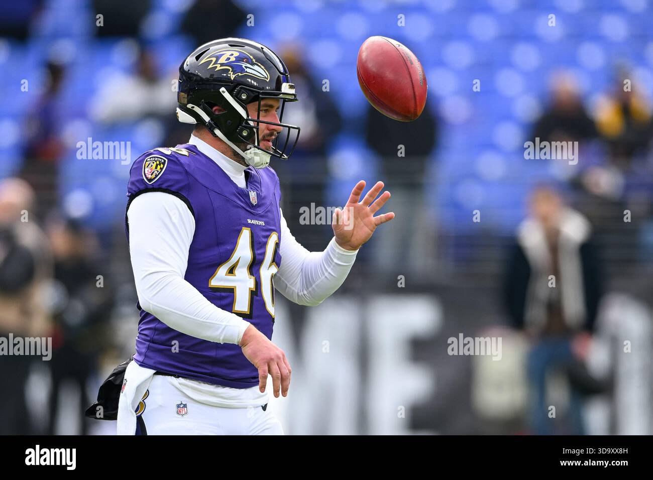 Baltimore Ravens long snapper Nick Moore (46) handles a football during ...