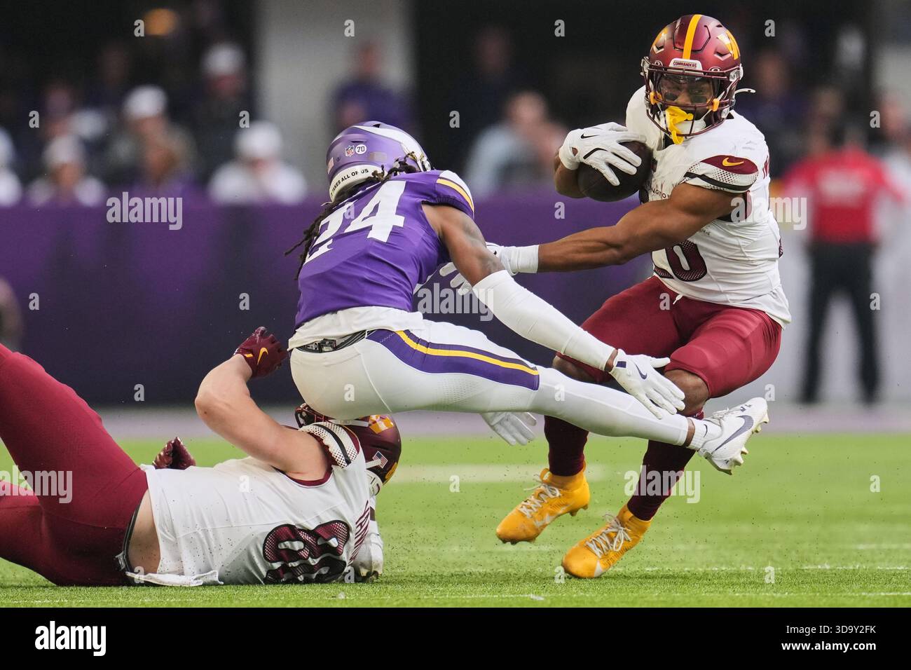 Washington Commanders running back Jeremy McNichols, right, breaks away ...