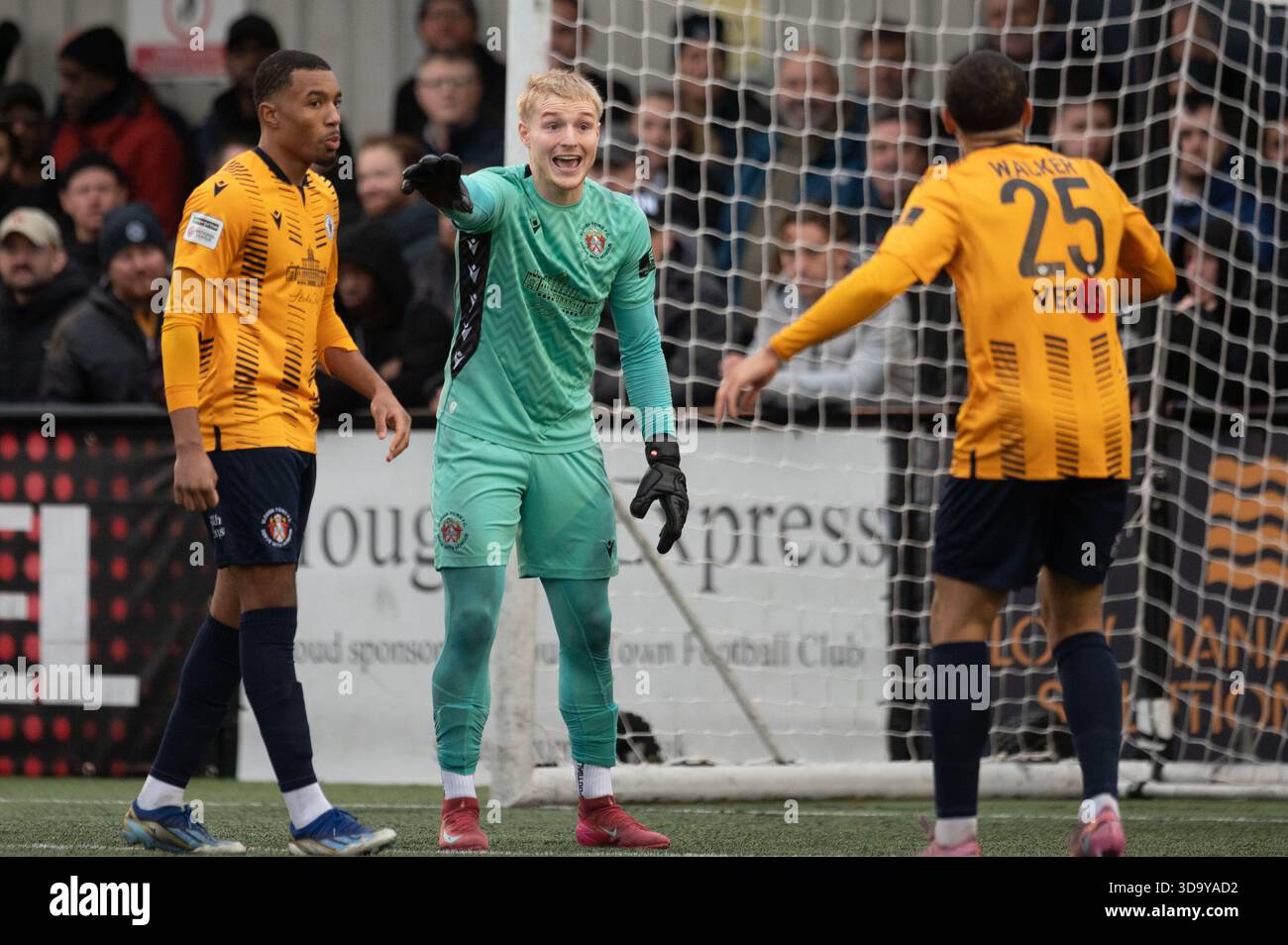 Slough, England. 7th Dec 2025. Slough Town’s Adam Desbois (centre ...