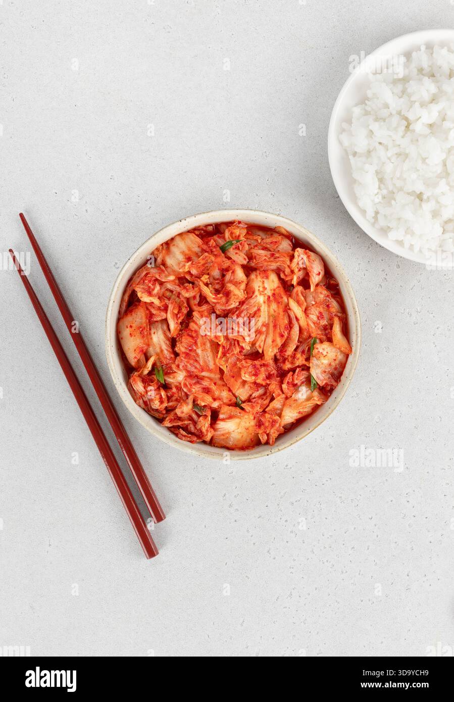 Korean fermented cabbage kimchi in bowl with steamed rice and wooden ...