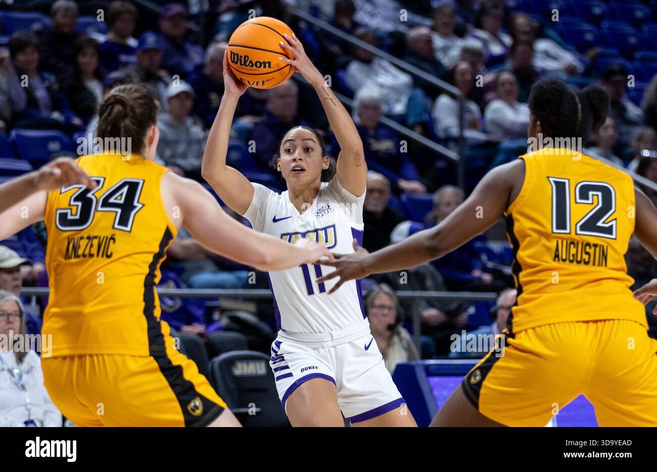 James Madison guard Bree Robinson (11) looks for an opening against VCU ...