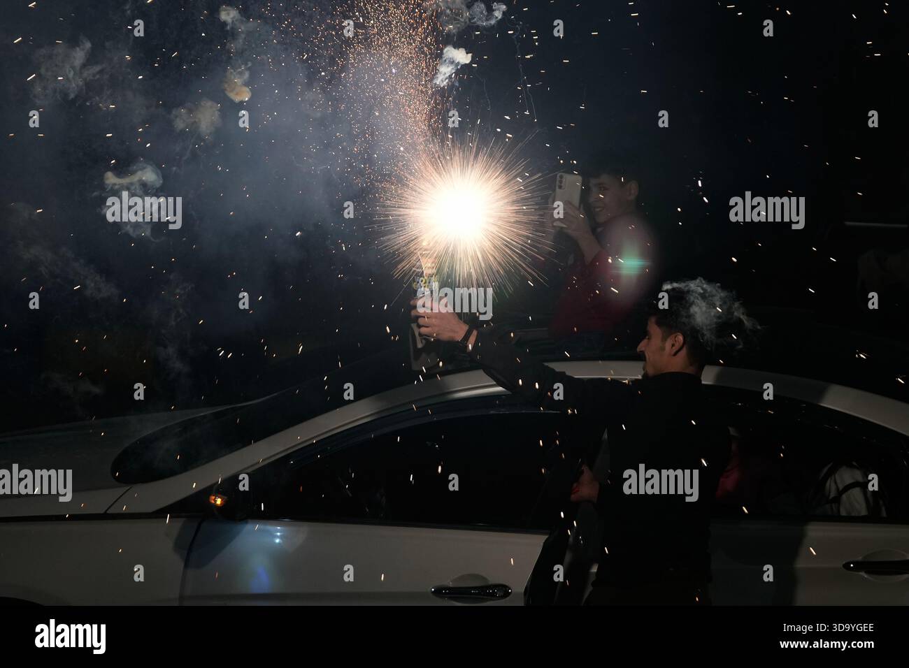 A Syrian man discharges fireworks during celebrations marking the first ...
