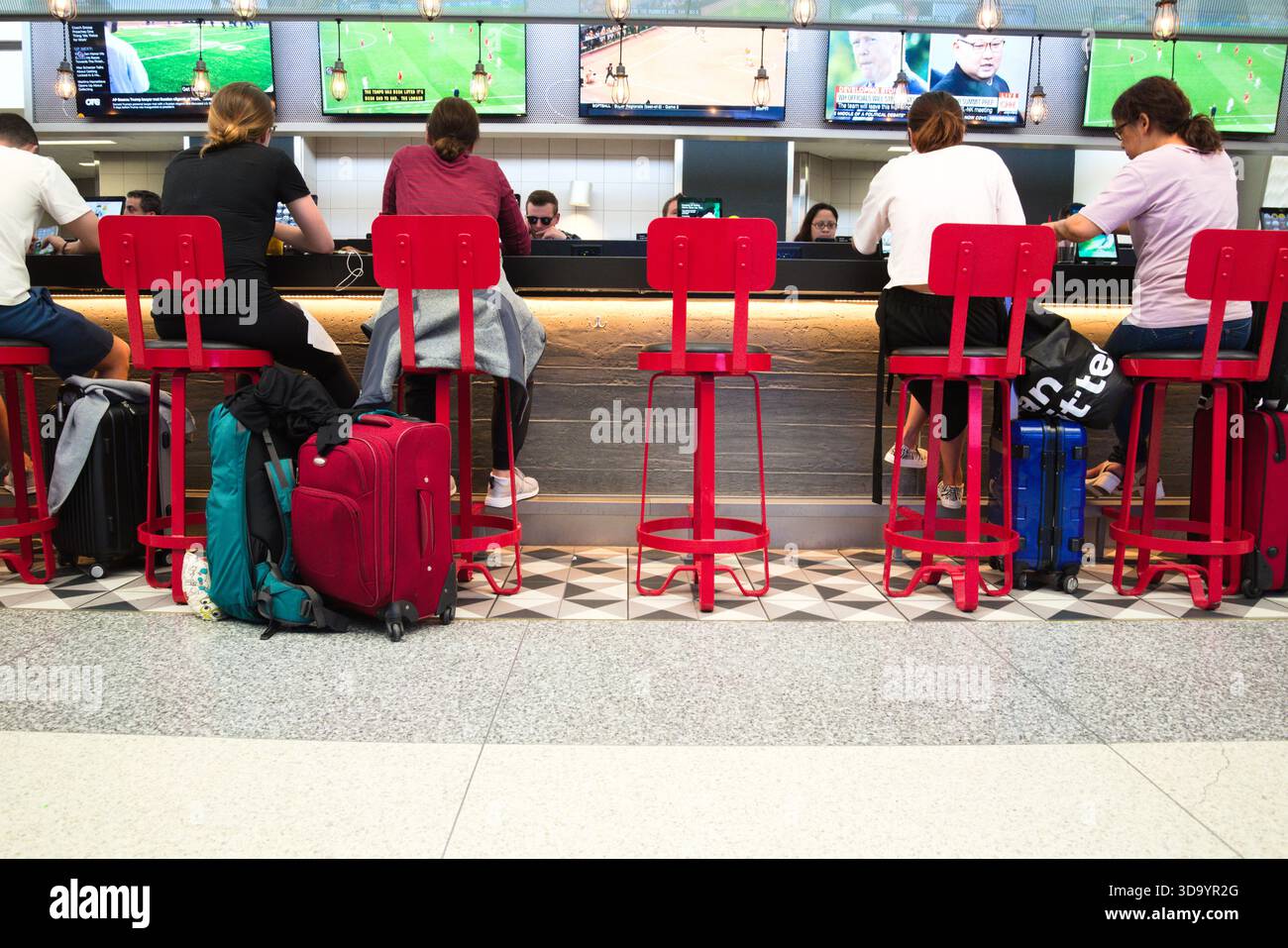 Red stools at an airport lunch counter Stock Photo - Alamy