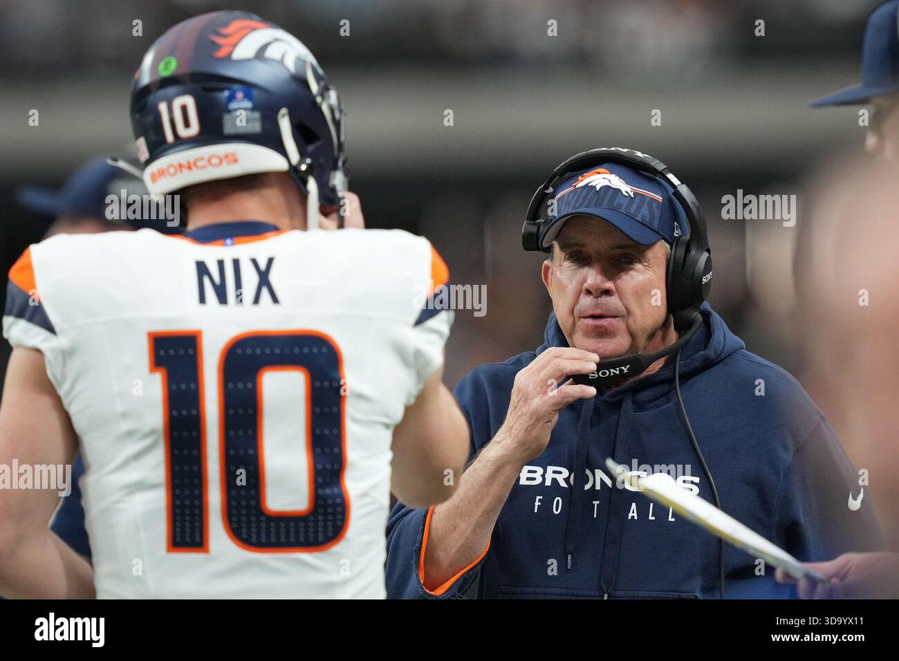 Denver Broncos quarterback Bo Nix (10) talks with head coach Sean ...