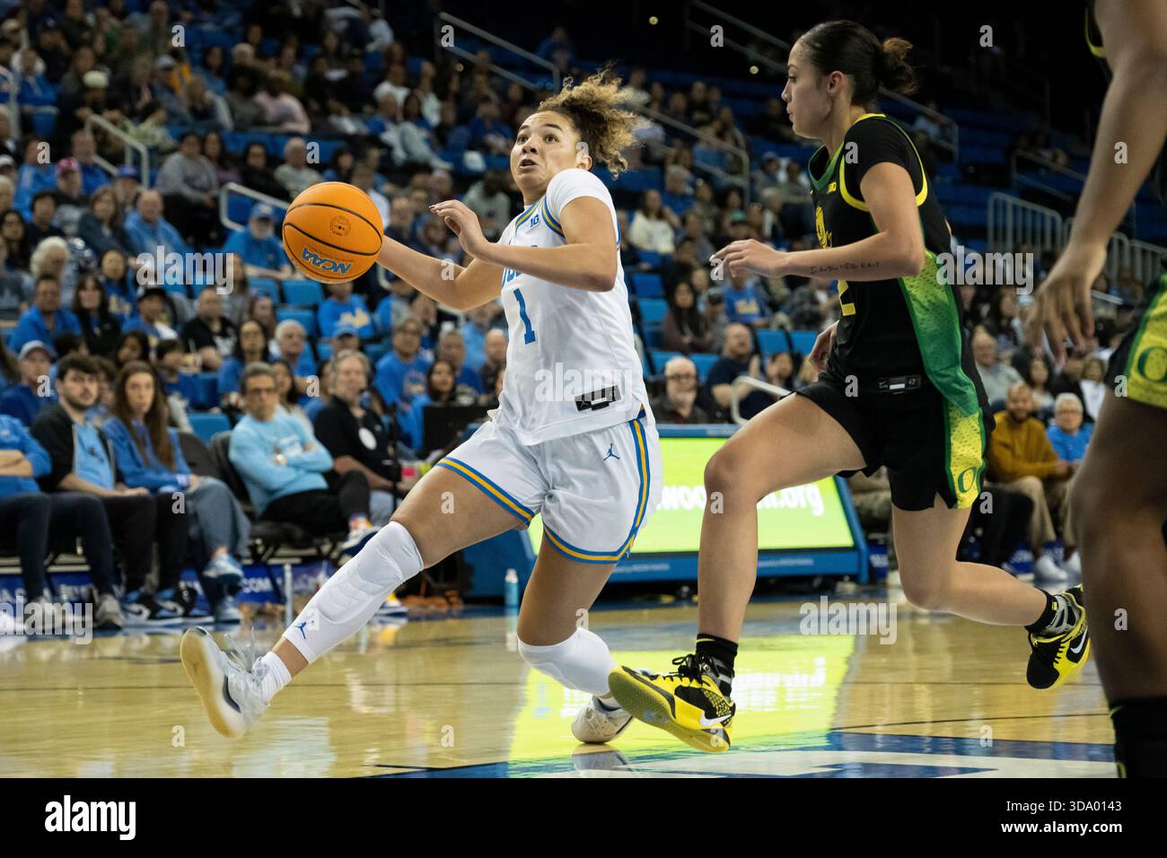 UCLA guard Kiki Rice (1) drives to the basket as Oregon guard Katie ...