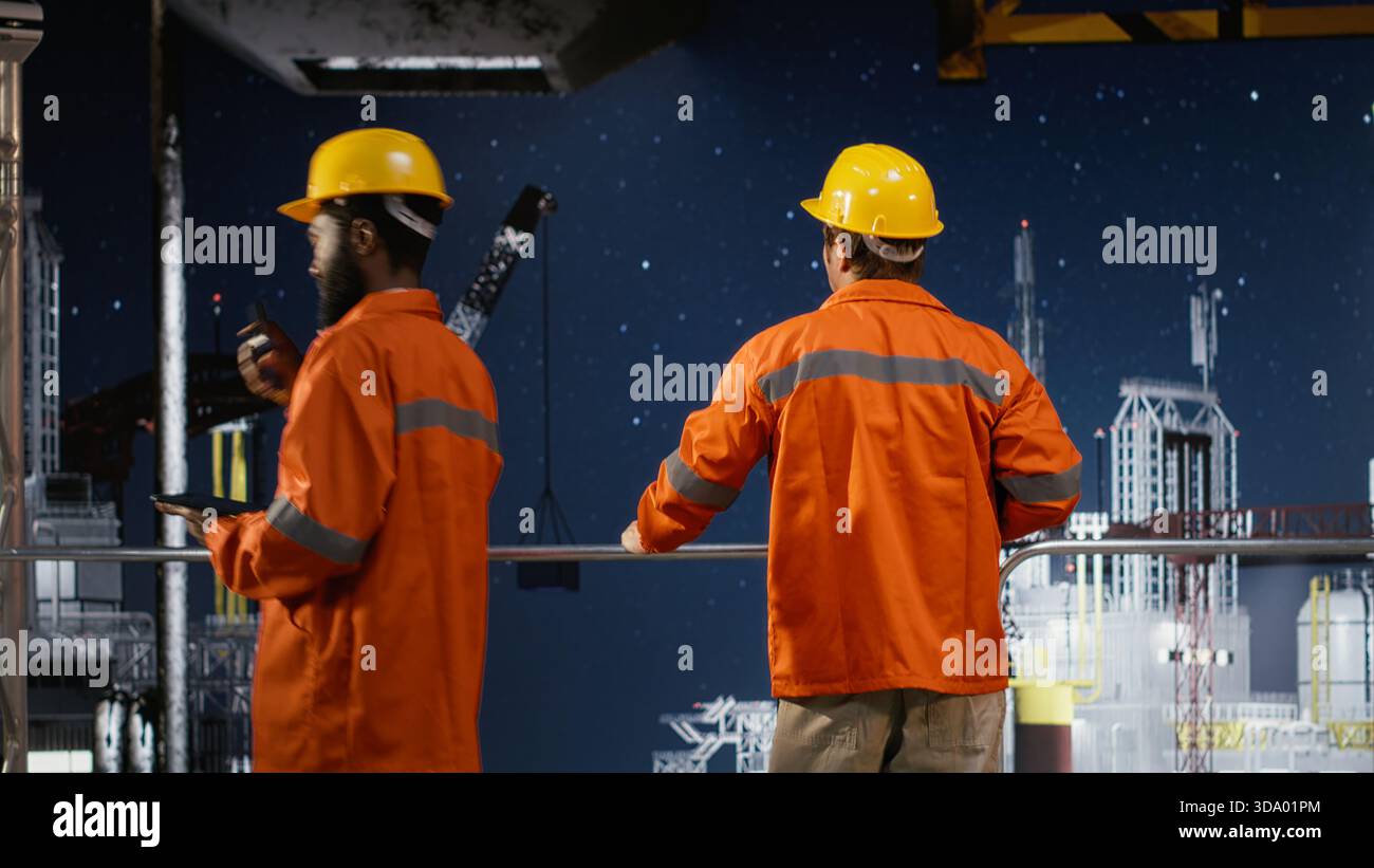 Worker in hard hat conducts system inspections on offshore drilling rig ...
