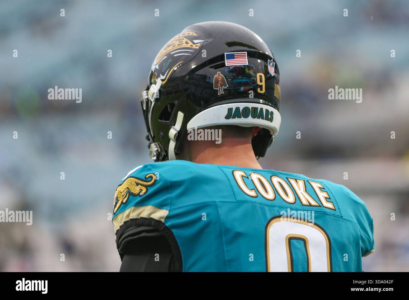 Jacksonville Jaguars punter Logan Cooke (9) warms up wearing a helmet ...