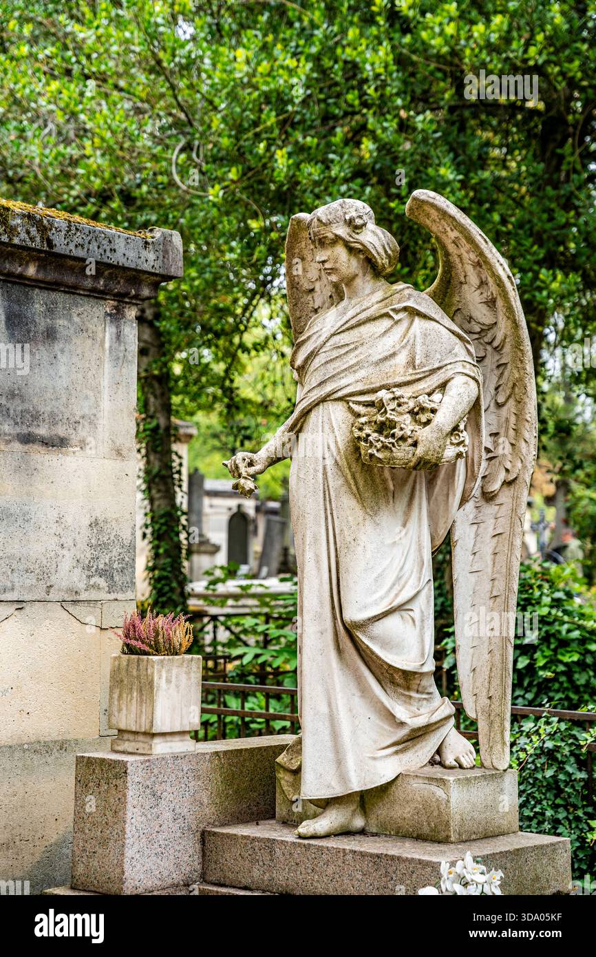 A statue of an angel among monumental graves in the Cemetery of Pere ...