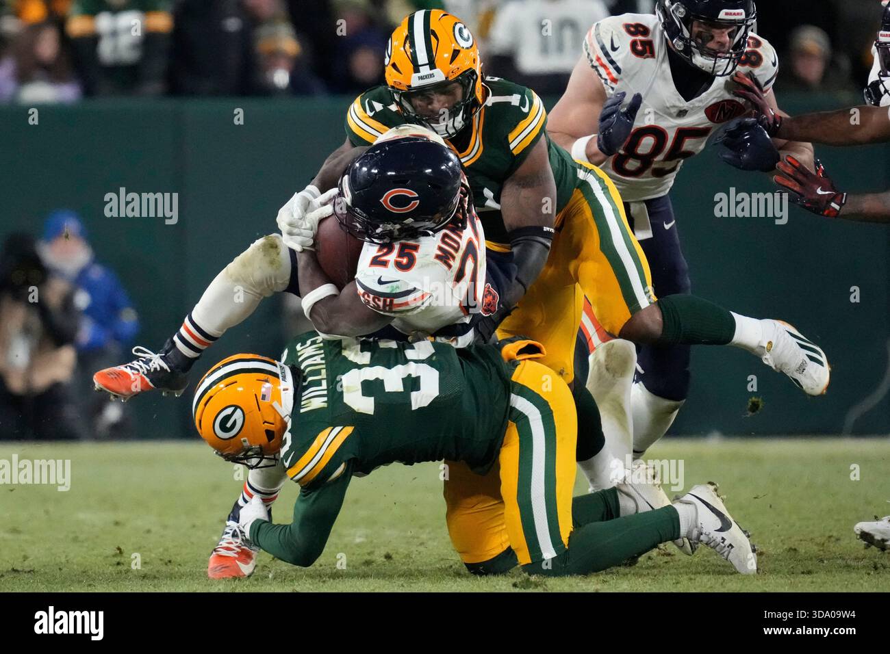 Green Bay Packers safety Evan Williams (33) and defensive end Micah ...