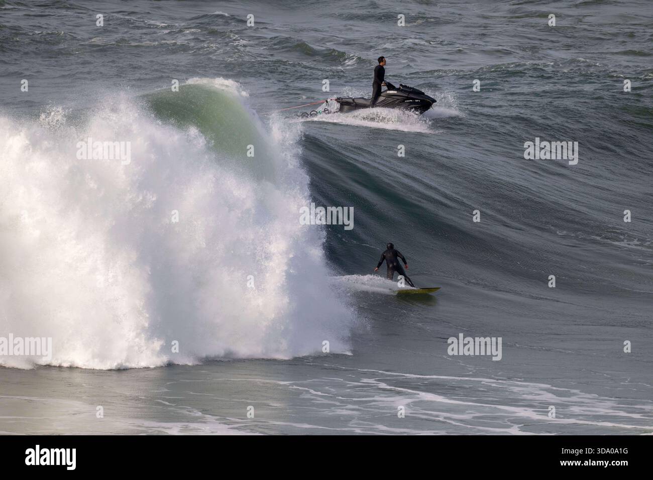 December 7, 2025, Nazare, Leiria, Portugal: A surfer rides a wave ...