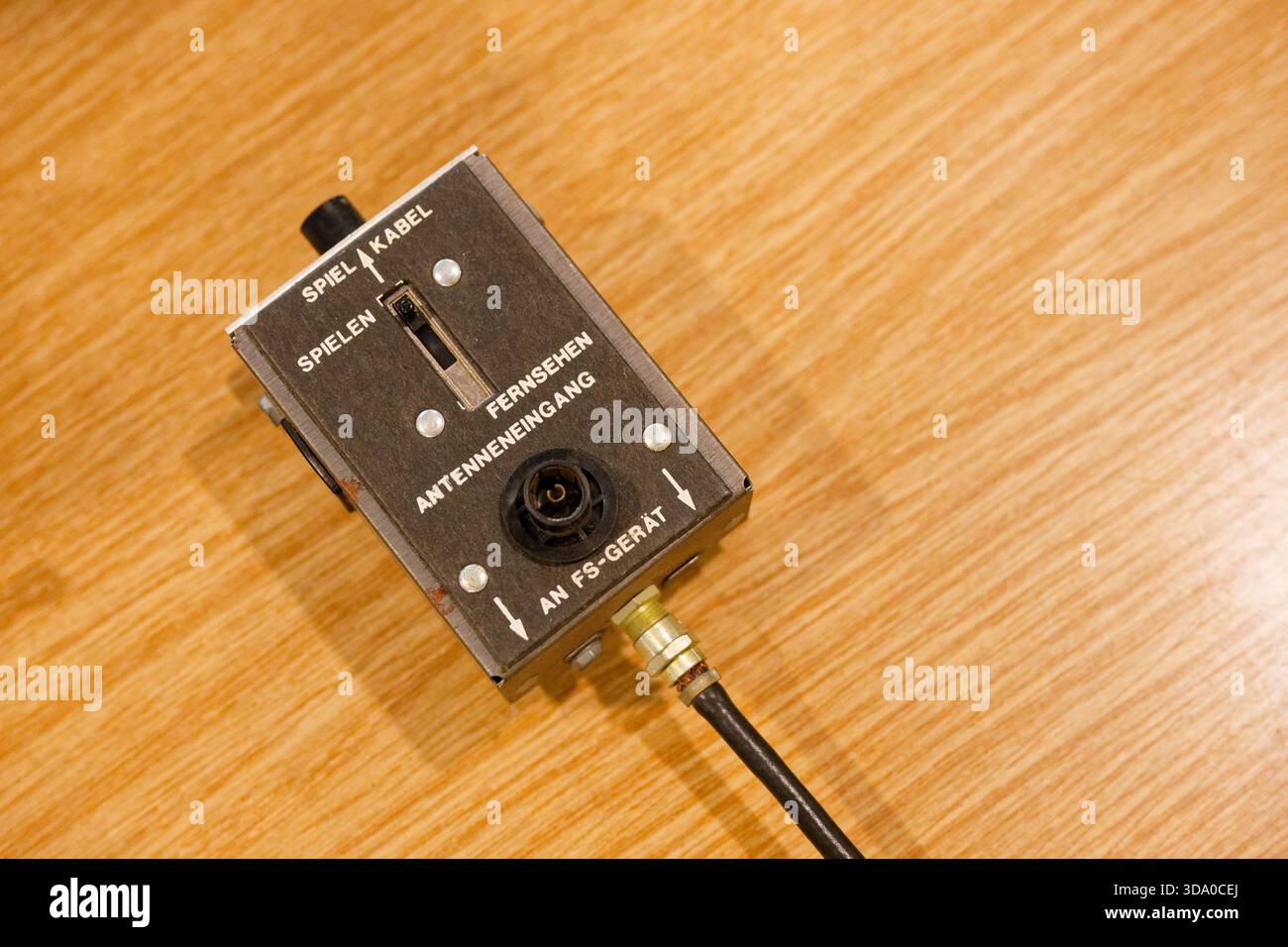 An old black junction box shows worn German labels for antenna ...