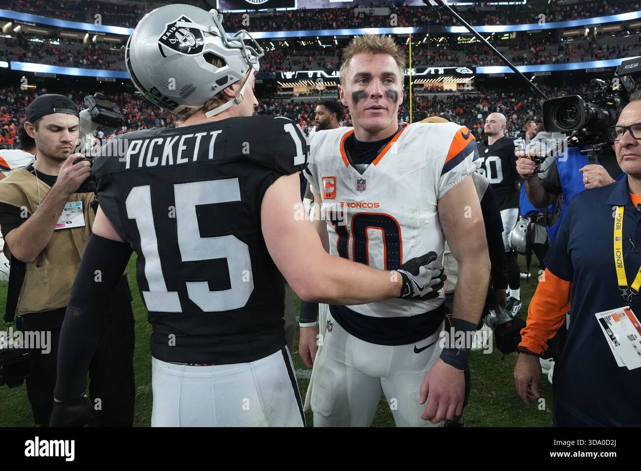 Las Vegas Raiders quarterback Kenny Pickett (15) greets Denver Broncos ...