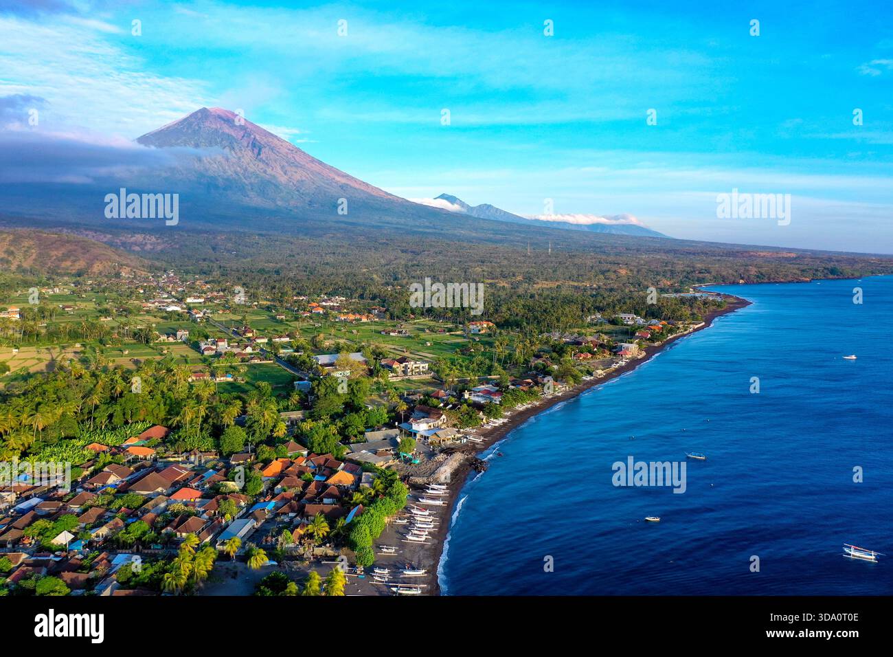 An aerial image of the coast and ocean at Amed, Bali with the iconic ...