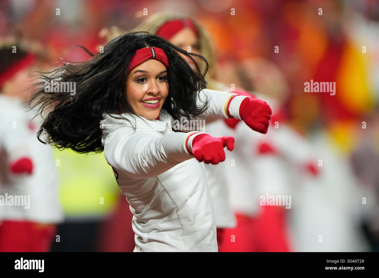 A cheerleader performs during the first half of an NFL football game ...