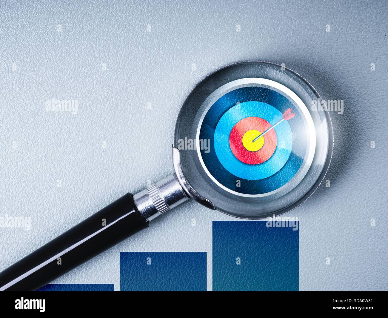 Close-up magnifying glass focusing on big bullseye target on top of ...