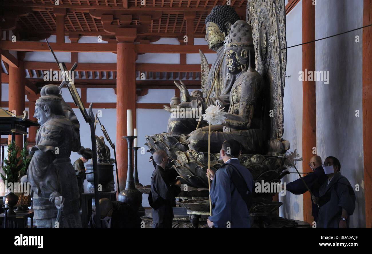 Monks brush dust off the Buddha statues at the Great Hall of Horyuji ...