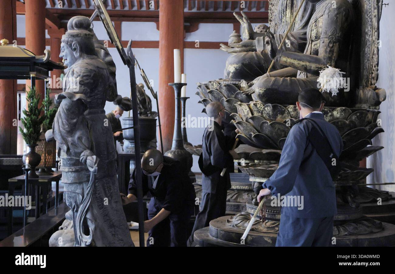 Monks brush dust off the Buddha statues at the Great Hall of Horyuji ...