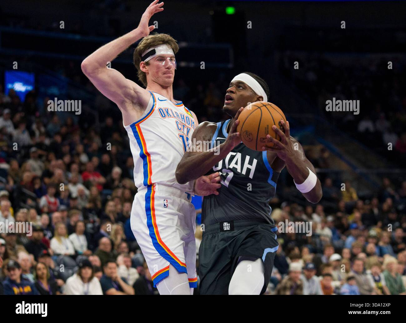Utah Jazz forward Taylor Hendricks, right, drives to the basket as ...