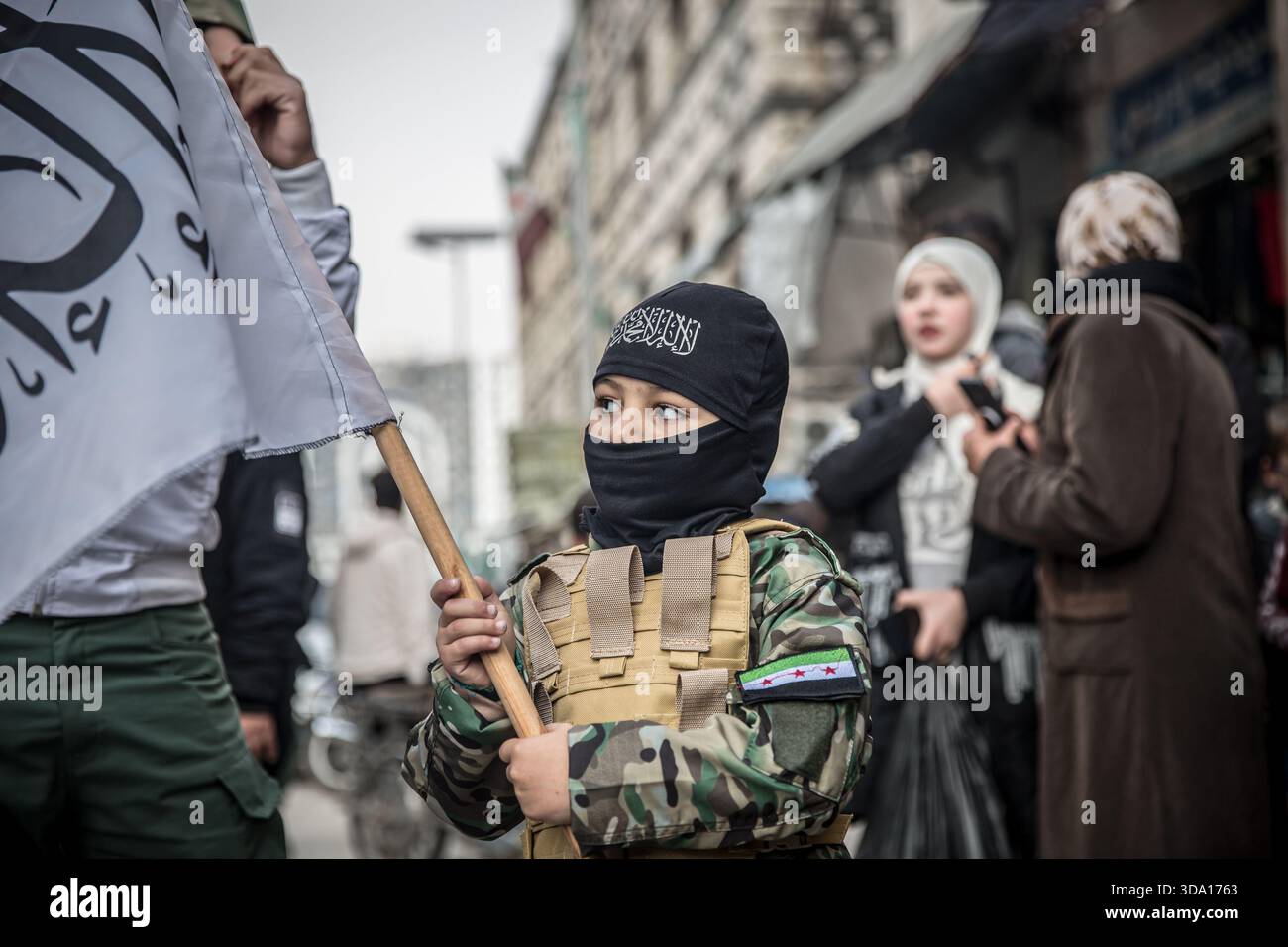 A Syrian child dressed up as a rebel fighter. Celebrations were held in ...