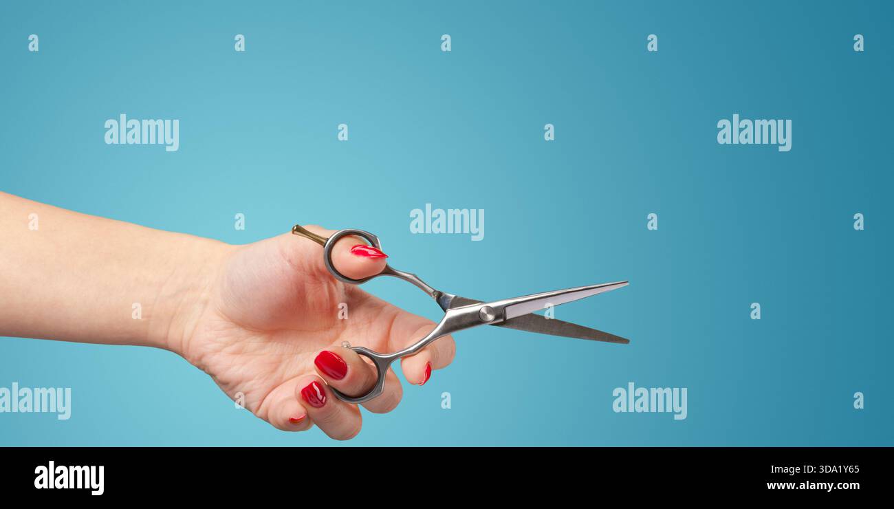 Hand holding sharp scissors designed for precision cutting and crafting ...
