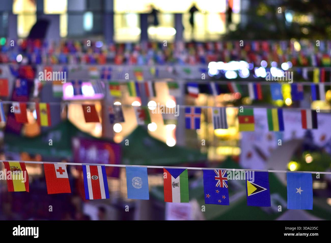Colorful international flags hanging in a festive outdoor setting Stock ...