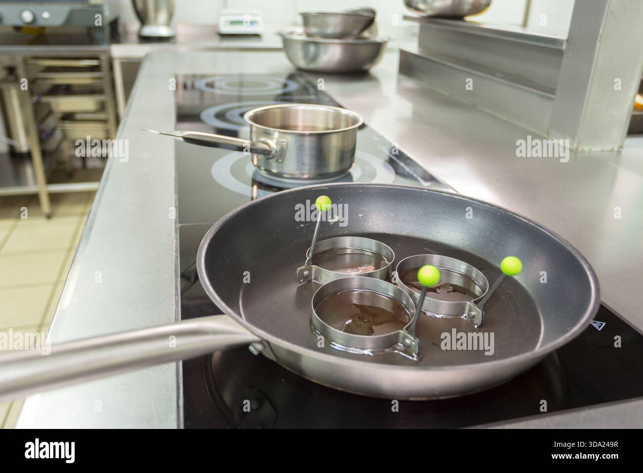 Cooking tools arranged on a stainless steel kitchen countertop during ...