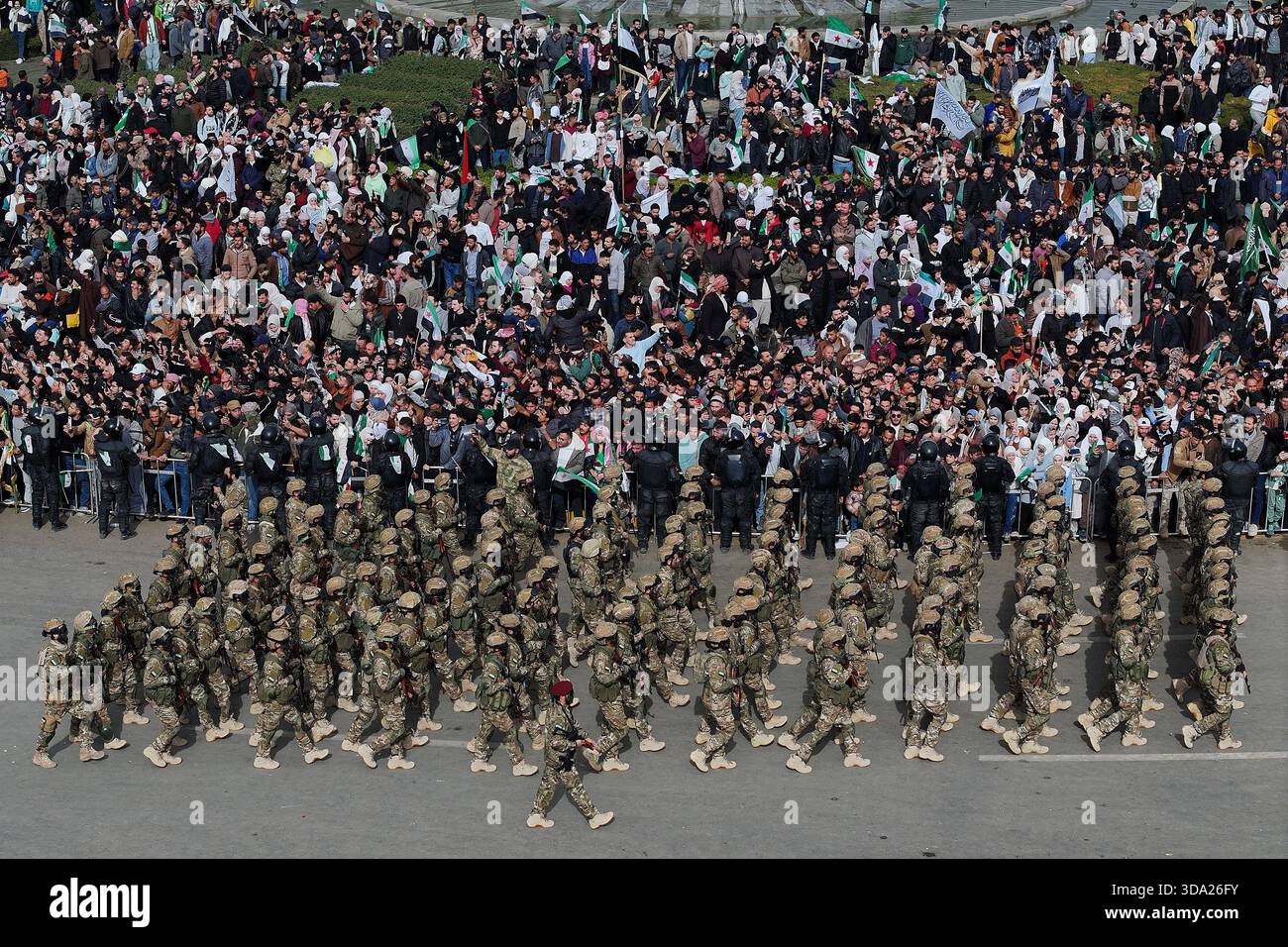 New Syrian army march during a parade marking the first anniversary of ...