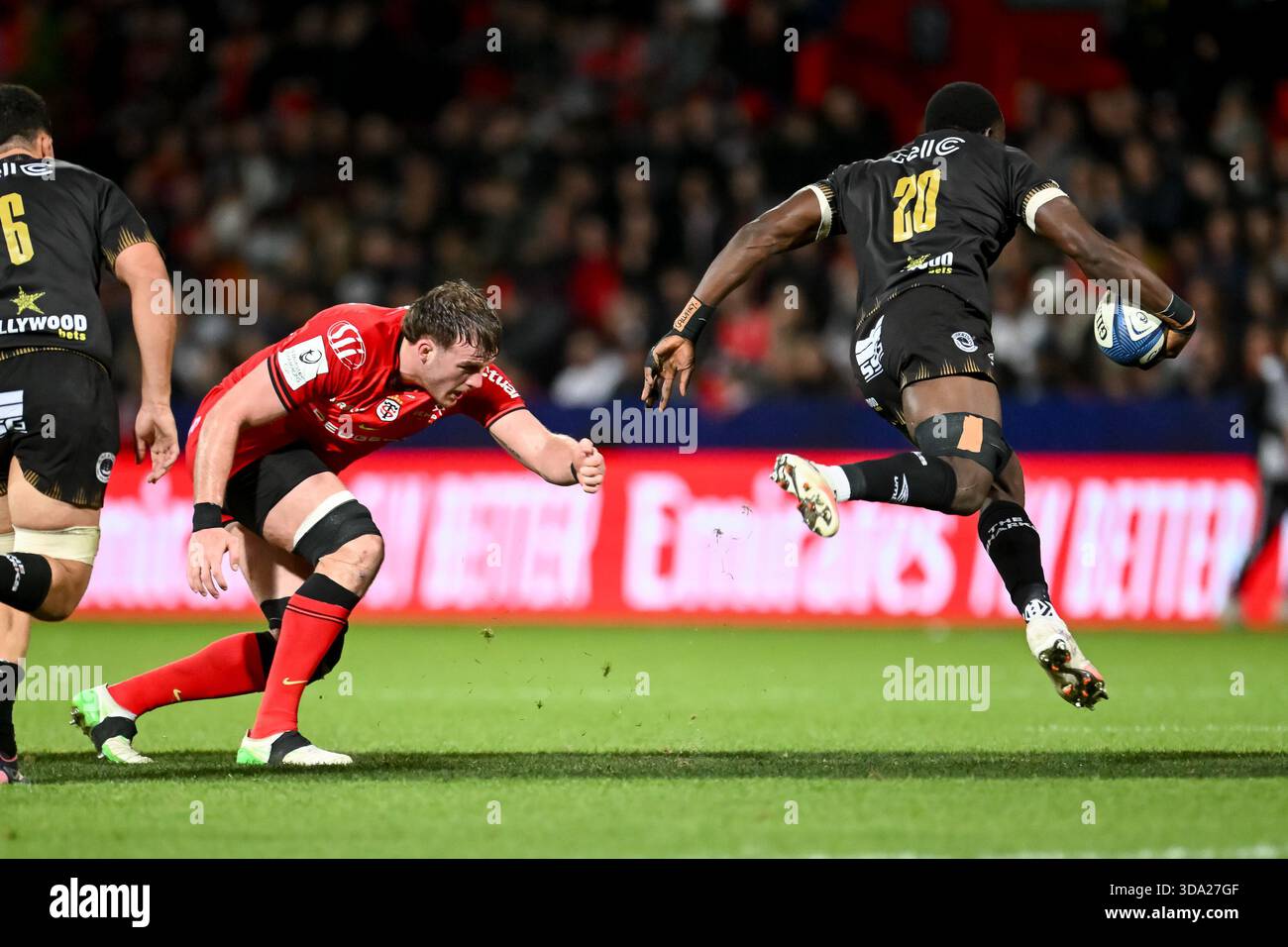 Joshua Brennan of Stade Toulousain and Tino Mavesere of Sharks during ...