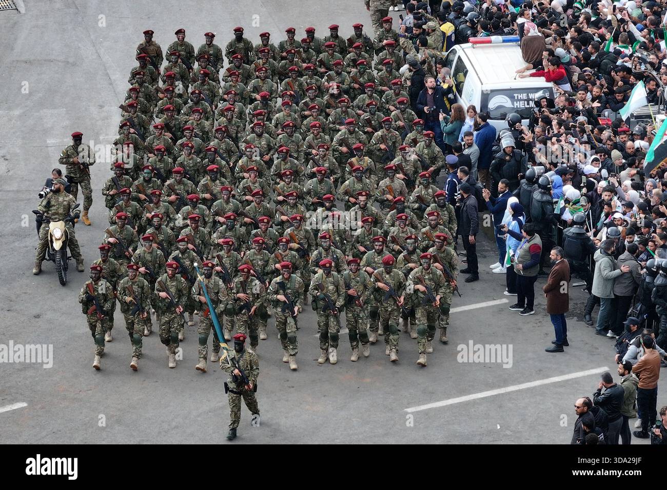 New Syrian army march during a parade marking the first anniversary of ...