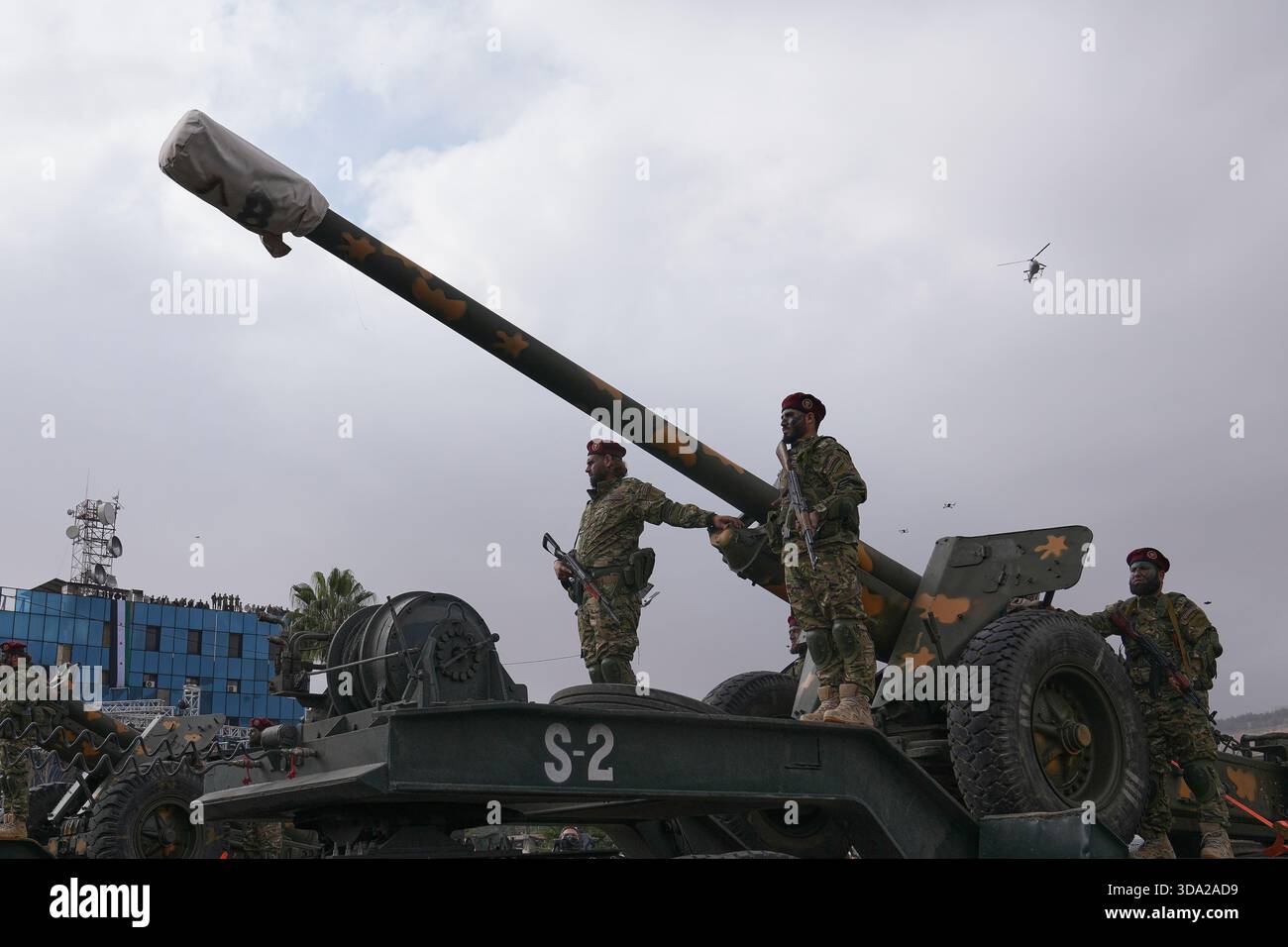New Syrian army soldiers stand next of an artillery cannon, as they ...