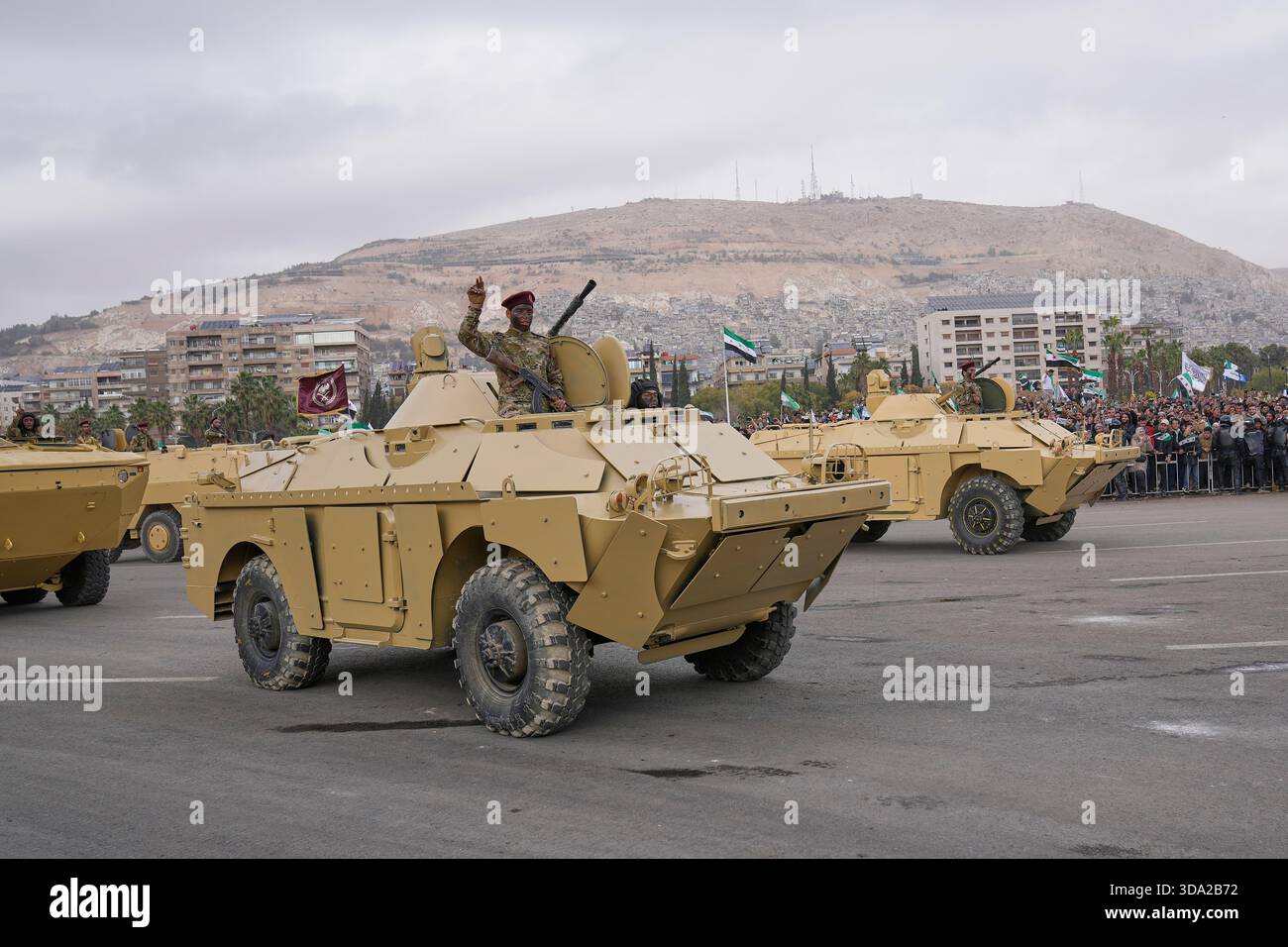 New Syrian army soldiers stand on their armoured personnel carriers ...