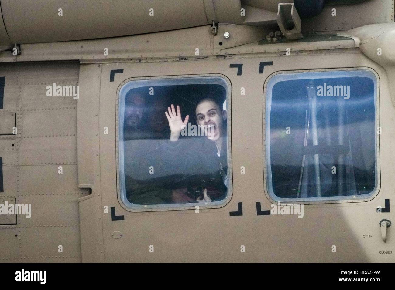 Freed Israeli hostage Omer Wenkert, gestures from a military helicopter ...