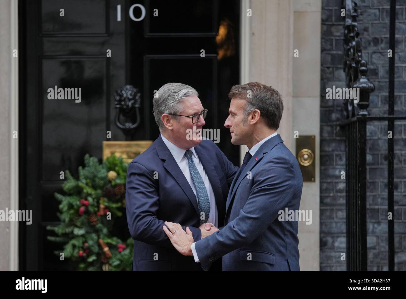 Britain's Prime Minister Keir Starmer, left, greets French President ...