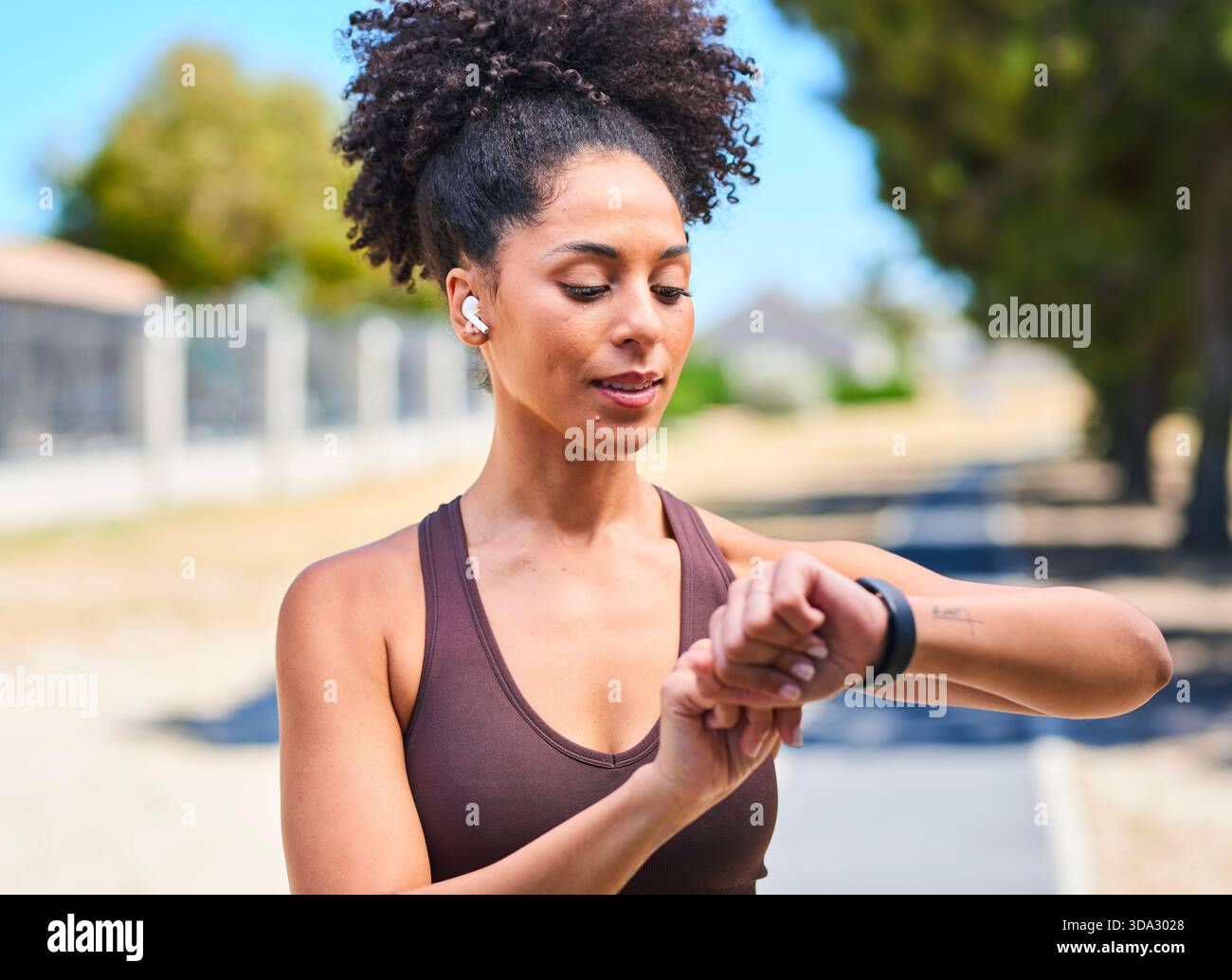 Woman checks smartwatch outdoors hi-res stock photography and images ...