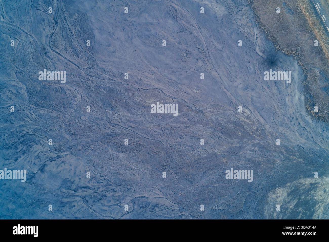 Aerial drone shot of a grey industrial slag pile slope with intricate ...