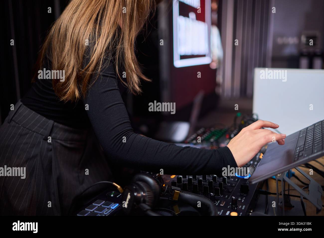 DJ setup overview, Energetic club DJ performing with digital controller ...