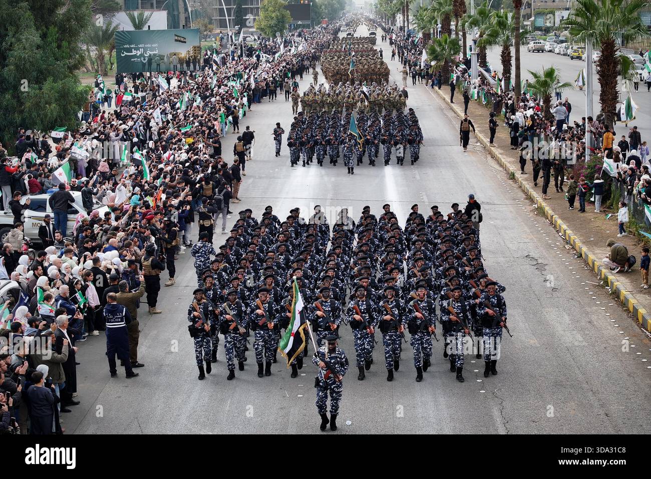 New Syrian army soldiers march during a parade marking the first ...