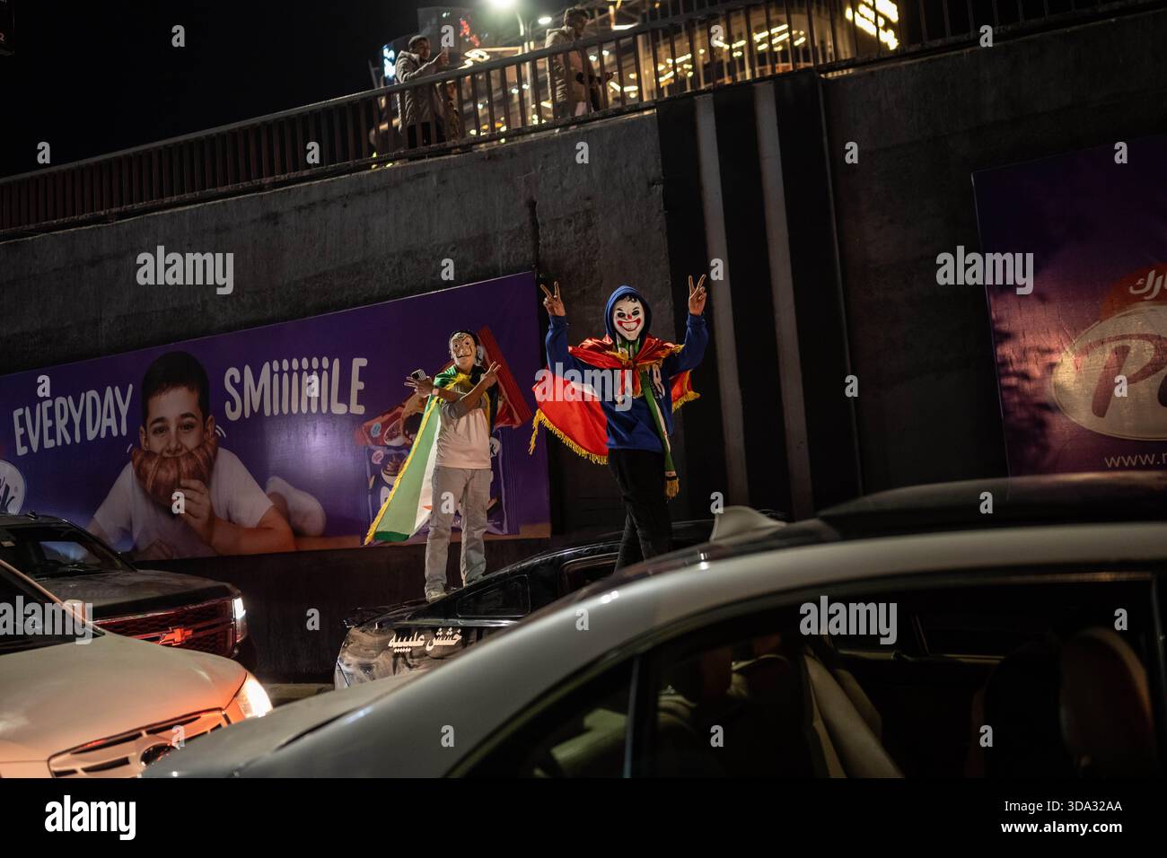 Syrians wave flags and drive around the streets of Damascus in ...